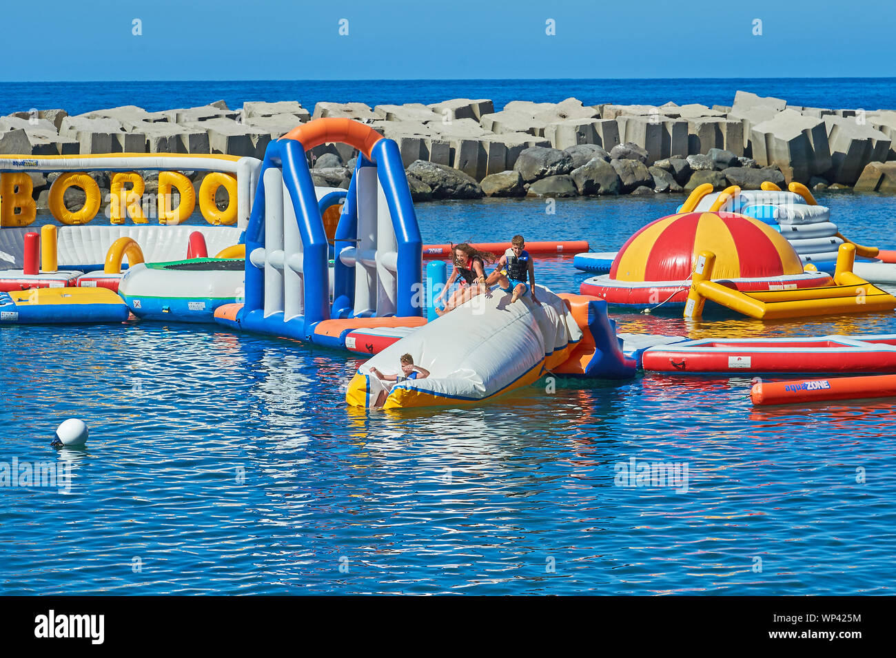 Calheta, Madeira and inflatable obstacles float in the man made harbour ...