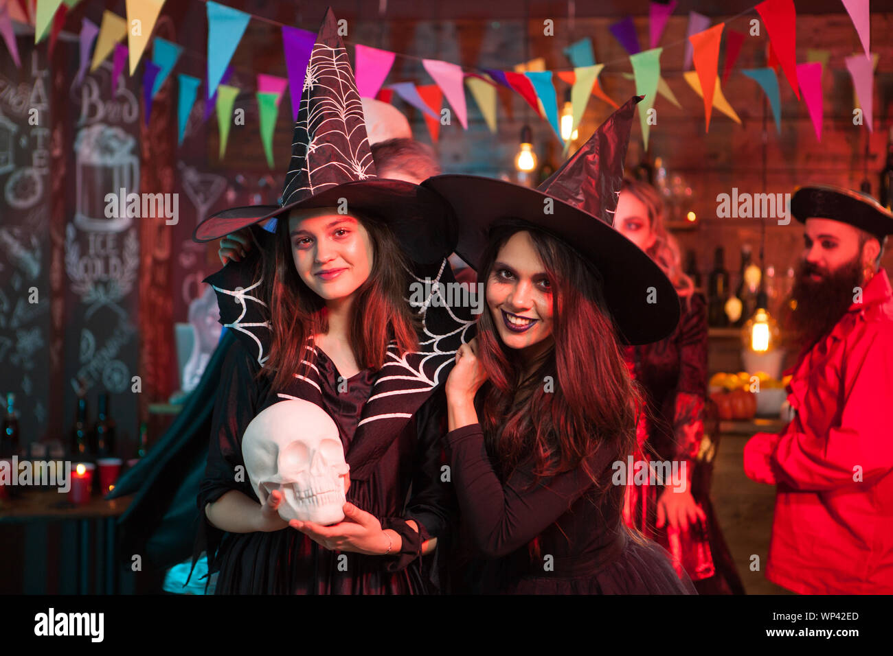 Portrait of excited young witches for halloween party. Beautiful ...