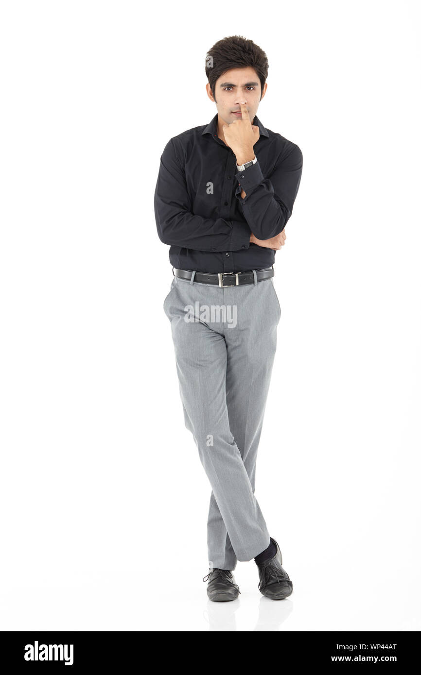Businessman standing with finger on lips Stock Photo - Alamy