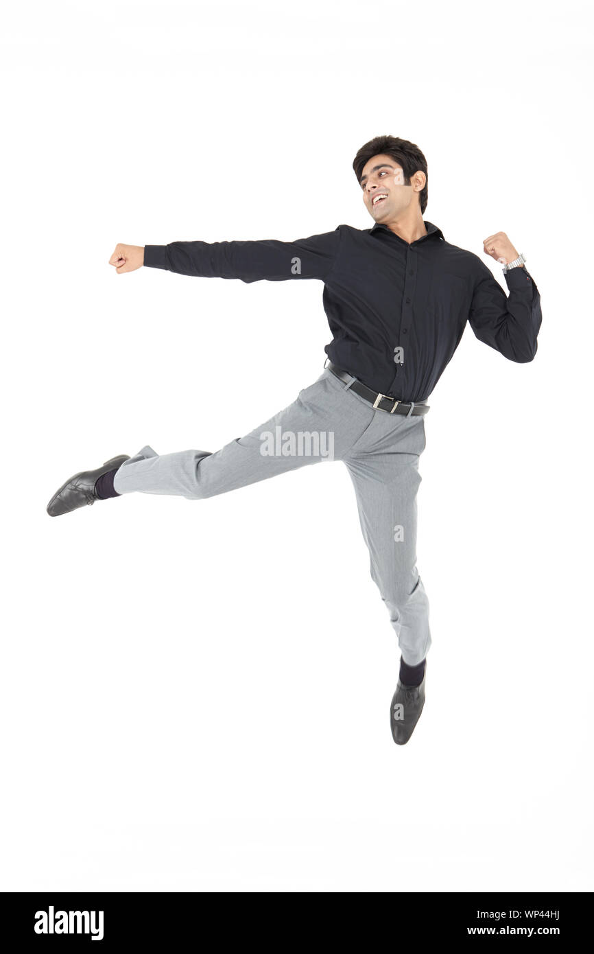 Man jumping and punching in air Cut Out Stock Images & Pictures - Alamy