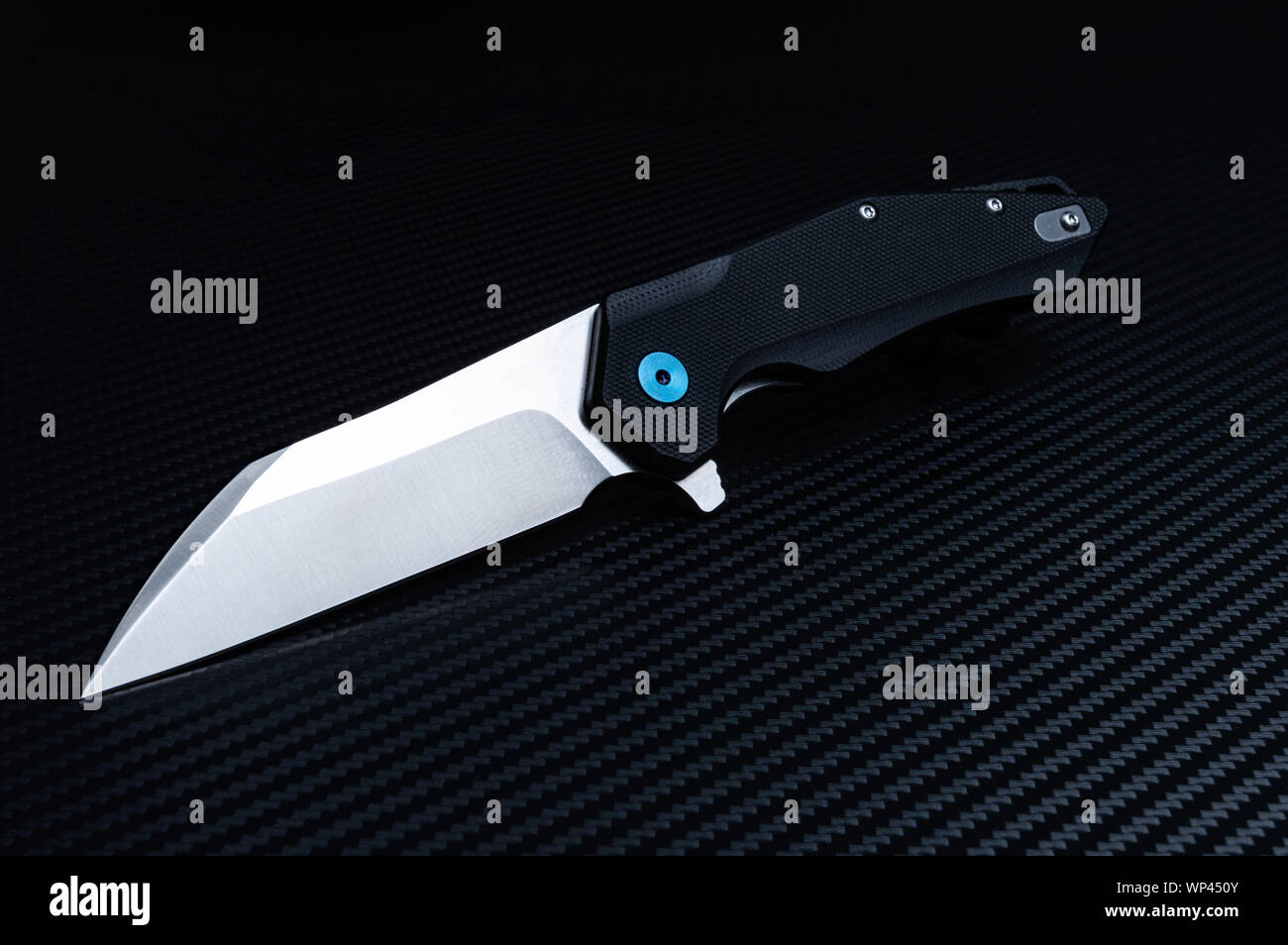 Folding pocket knife diagonally. Black background. Shiny blade Stock ...