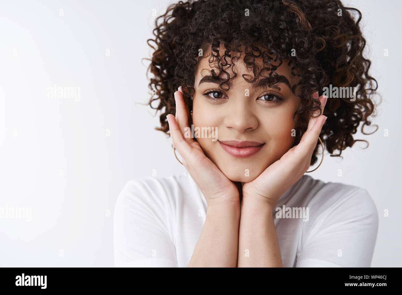 Headshot flirty attractive brunette curly hairstyle smiling happy ...