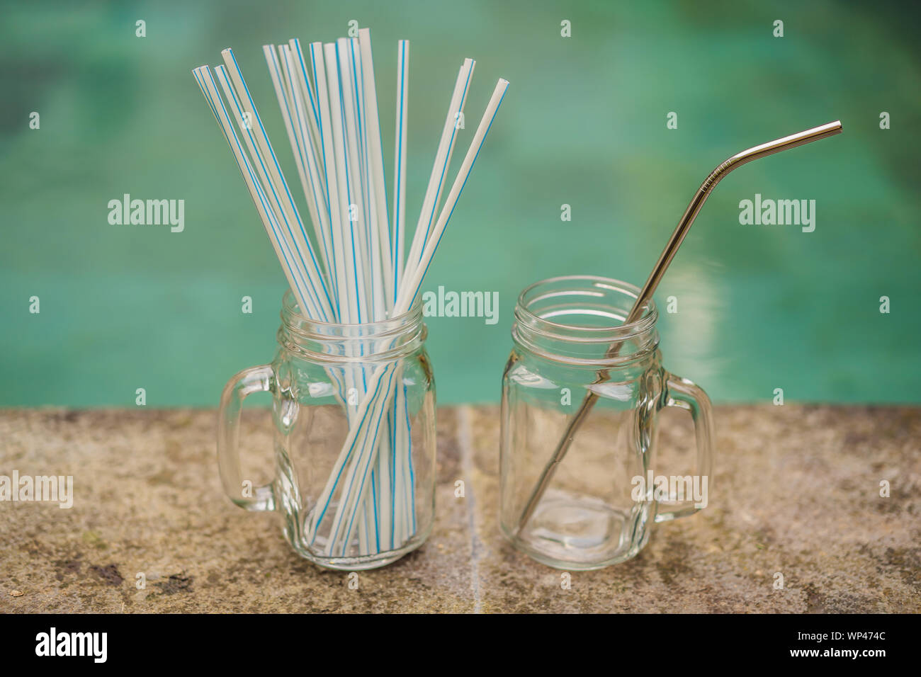 Steel drinking vs disposable straws on pool background. Zero waste ...