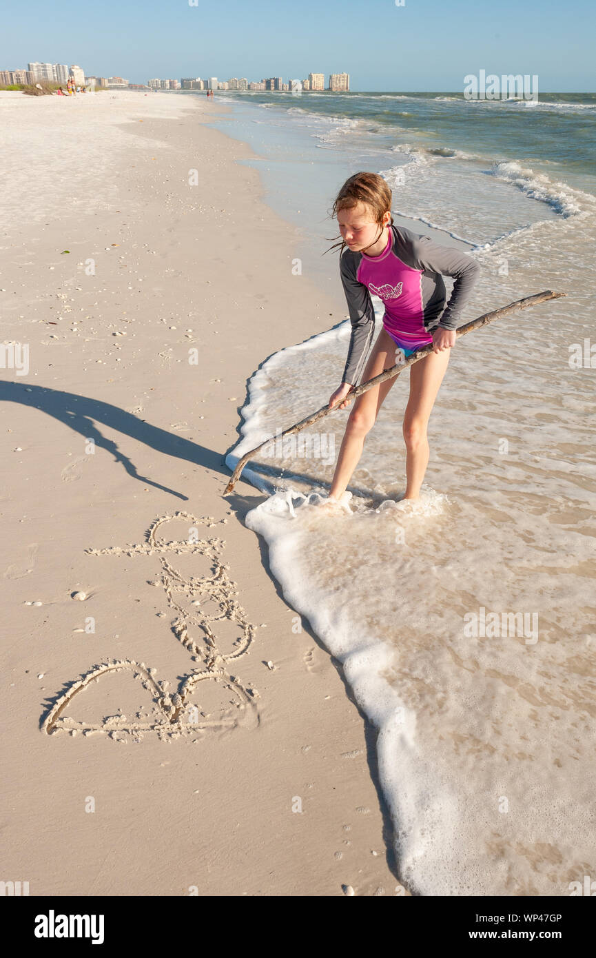 Kid writing in sand, Marco Island, FL, USA Stock Photo - Alamy
