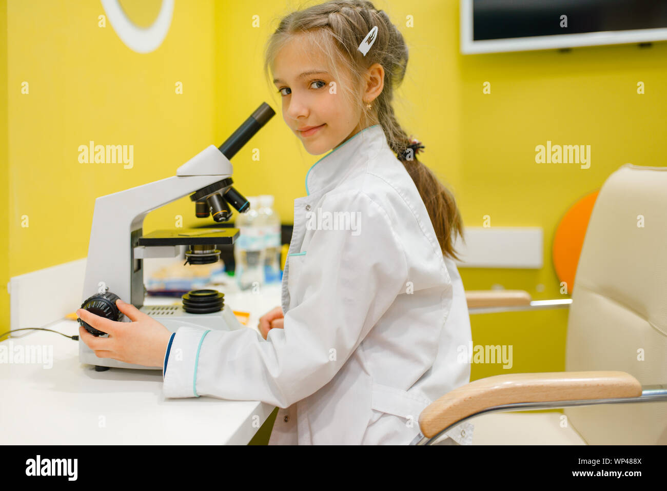 Girl at the microscope, playing doctor, playroom Stock Photo - Alamy