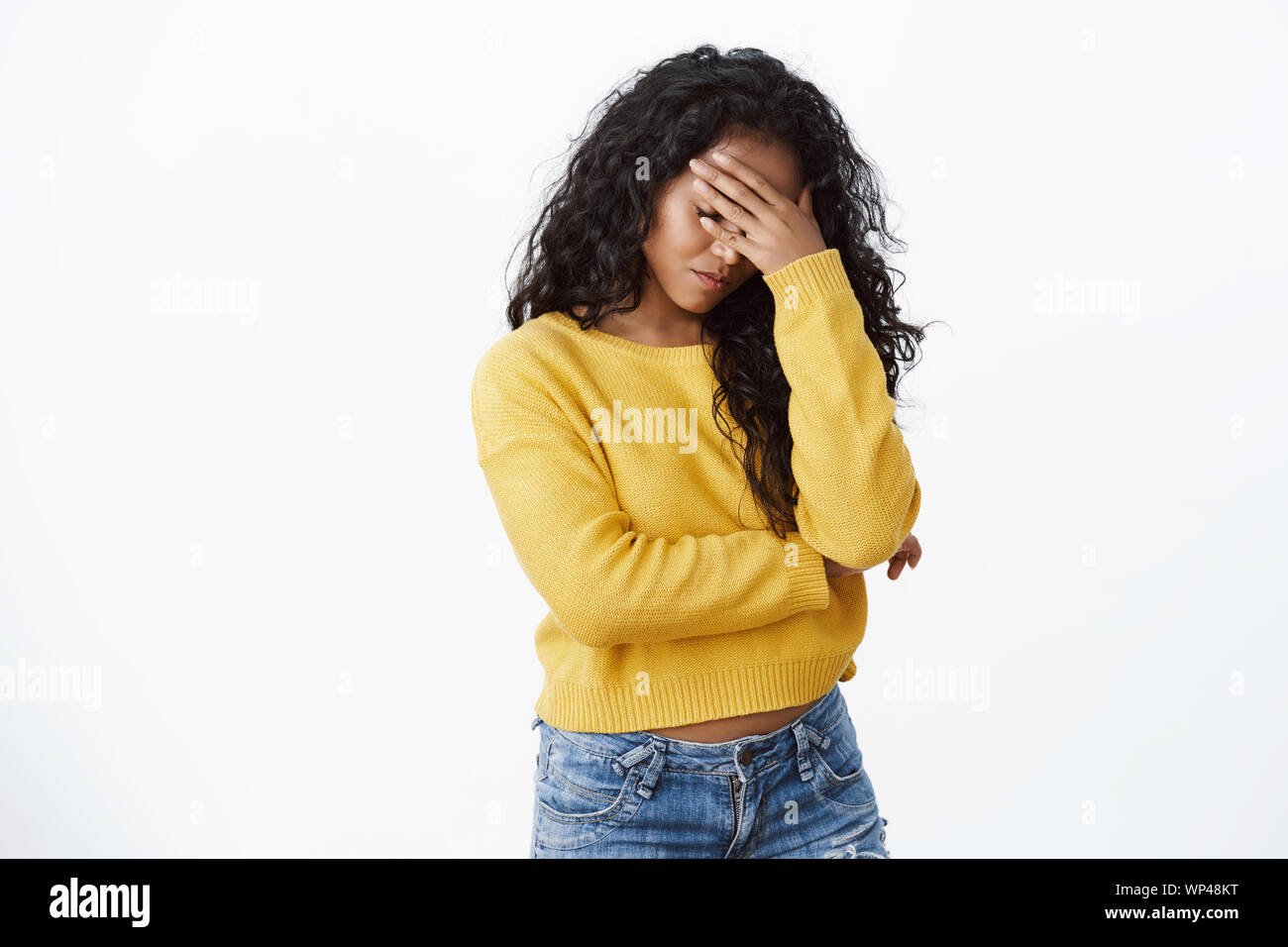 Drained and tired african-american woman in yellow sweater, making face ...