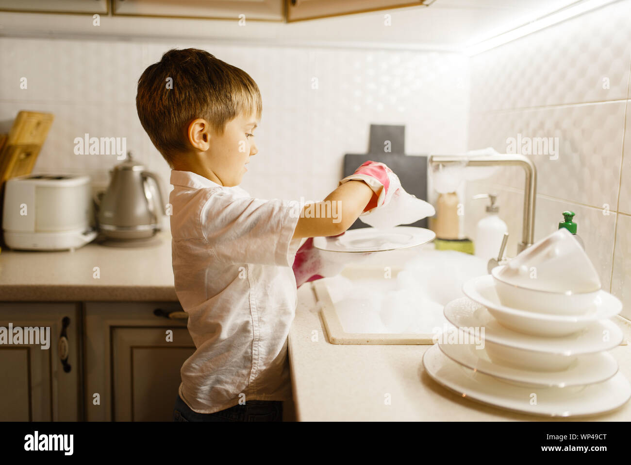 Boy washing dishes hi-res stock photography and images - Alamy