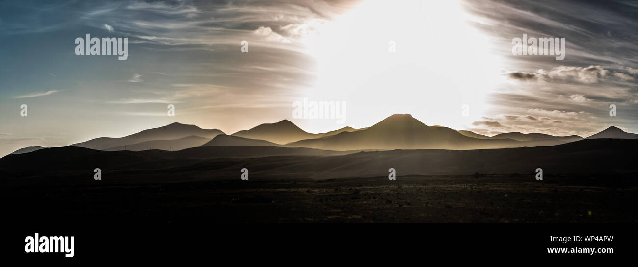 Desert landscape with volcano sun setting hi-res stock photography and ...