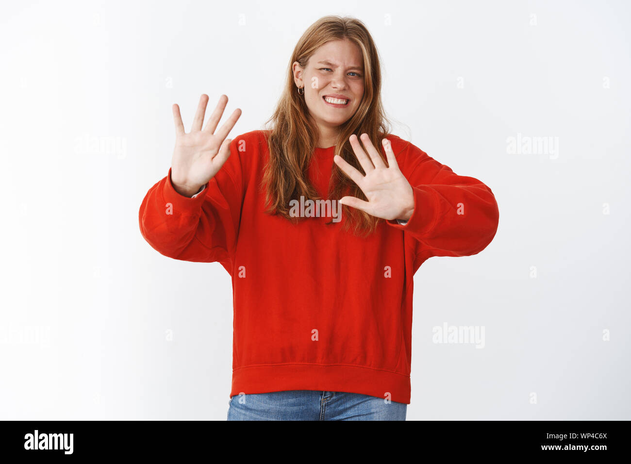 Girl feeling awkward rejecting dumb offer, smiling shy and blushing ...