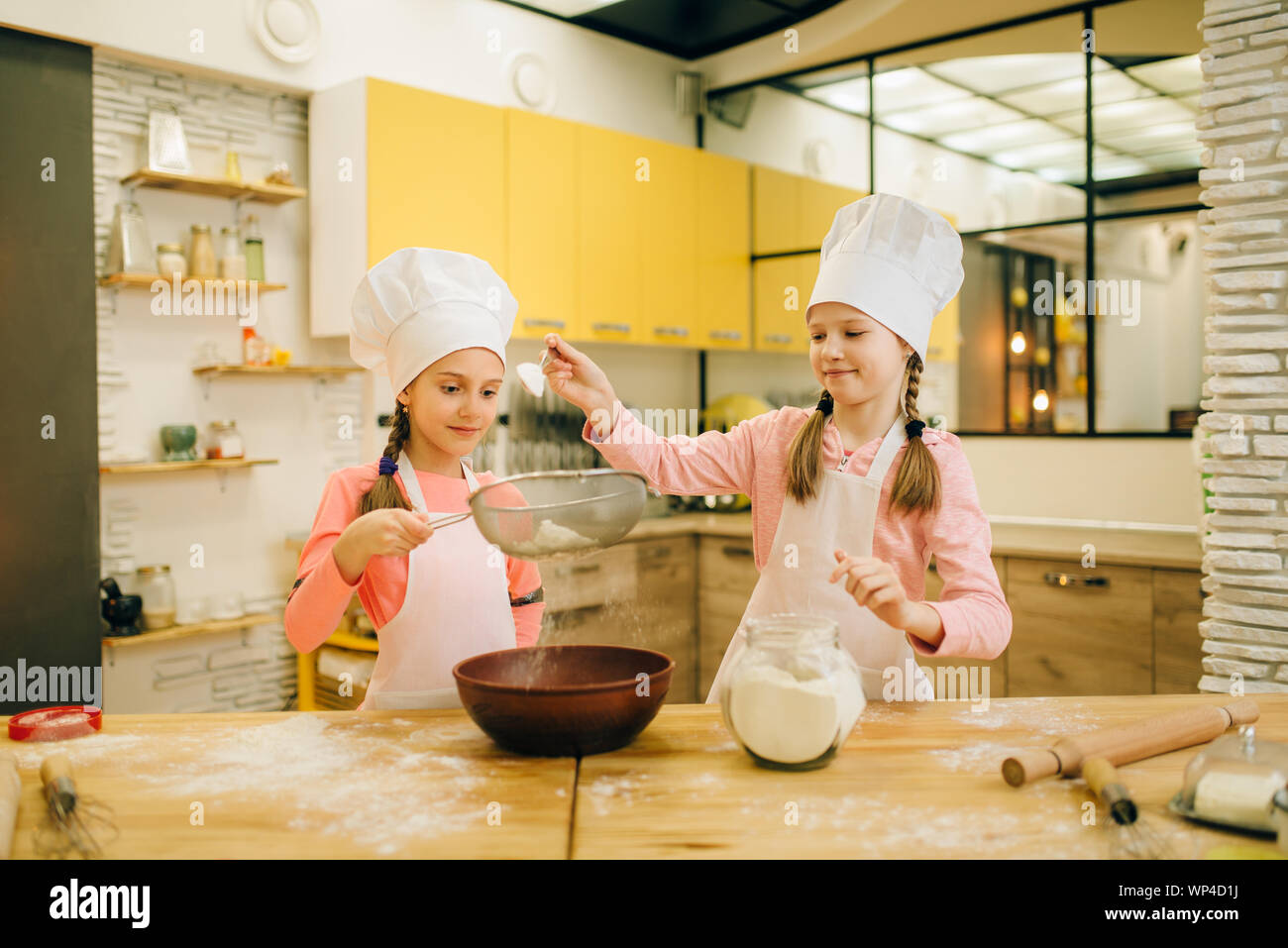 Girls cooks, cookies preparation on the kitchen Stock Photo - Alamy