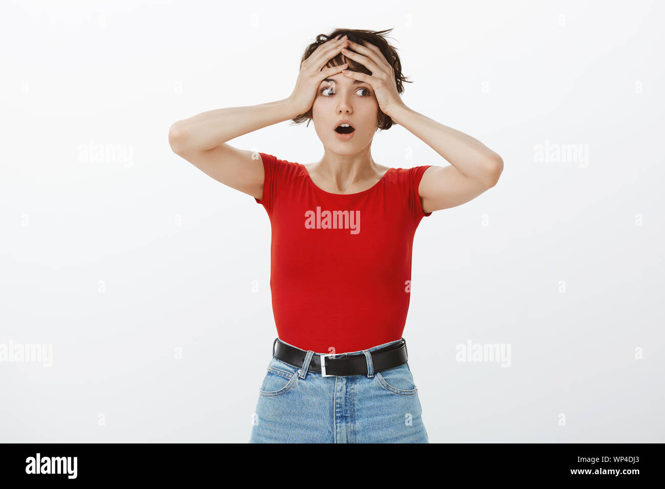 Wait what. Shocked stunned intense gasping woman grab head look aside ...