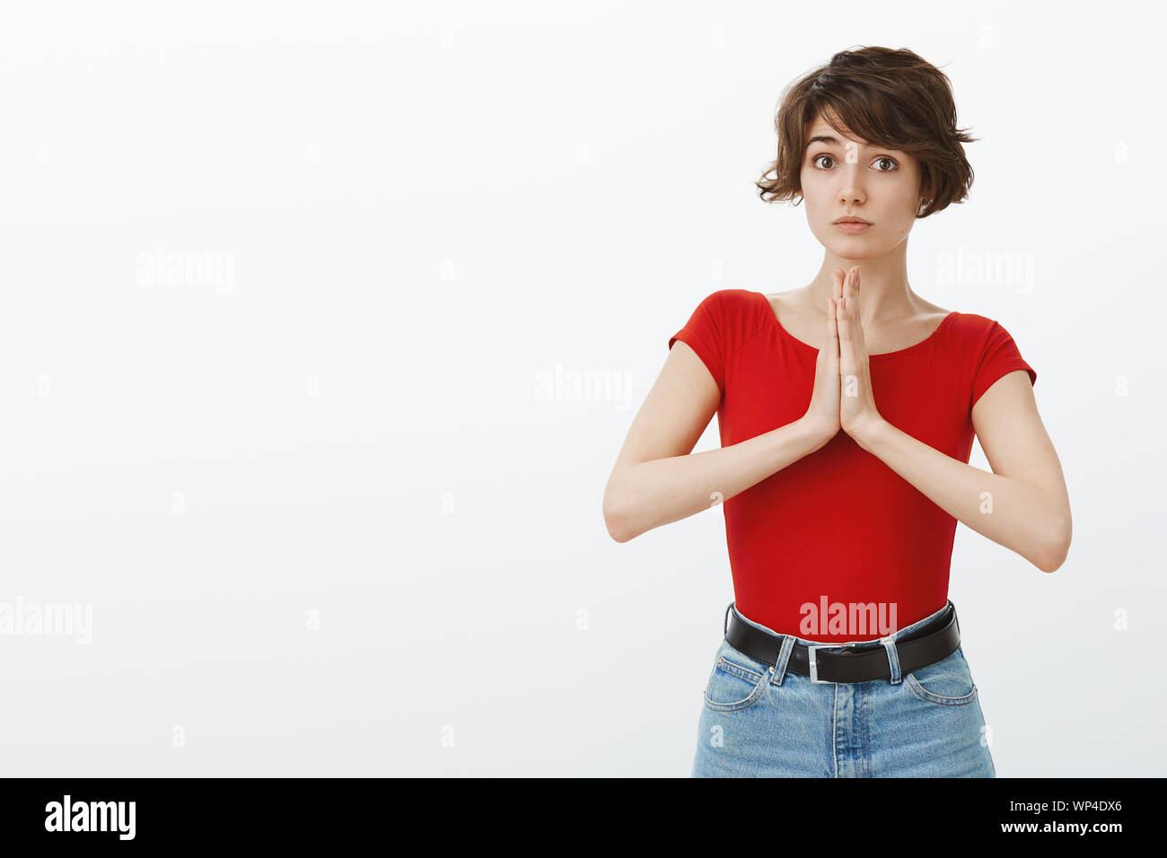 Silly cute timid woman short haircut press palms together supplication ...