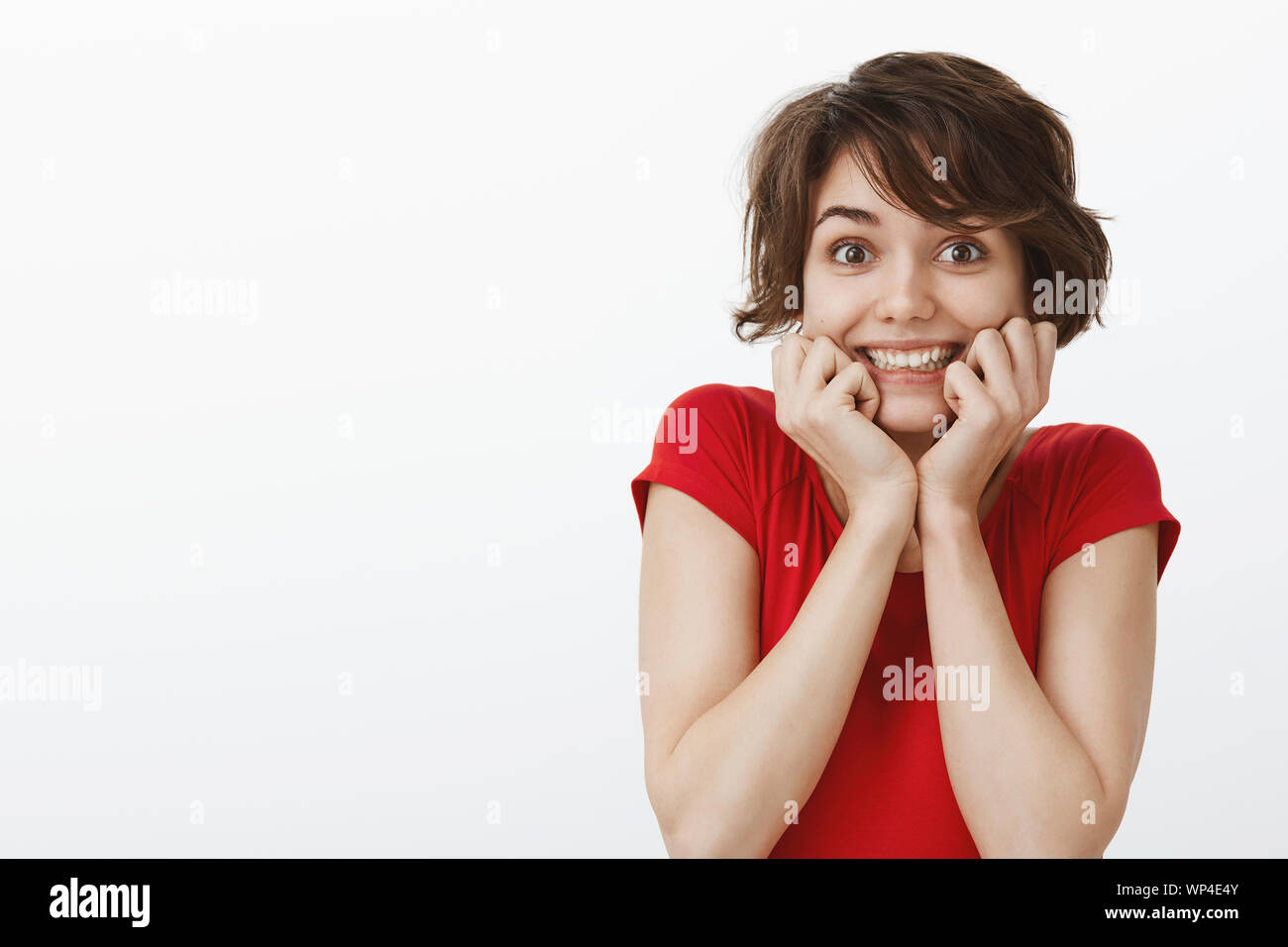 Close-up cheerful admiring tender silly woman short stylish haircut ...