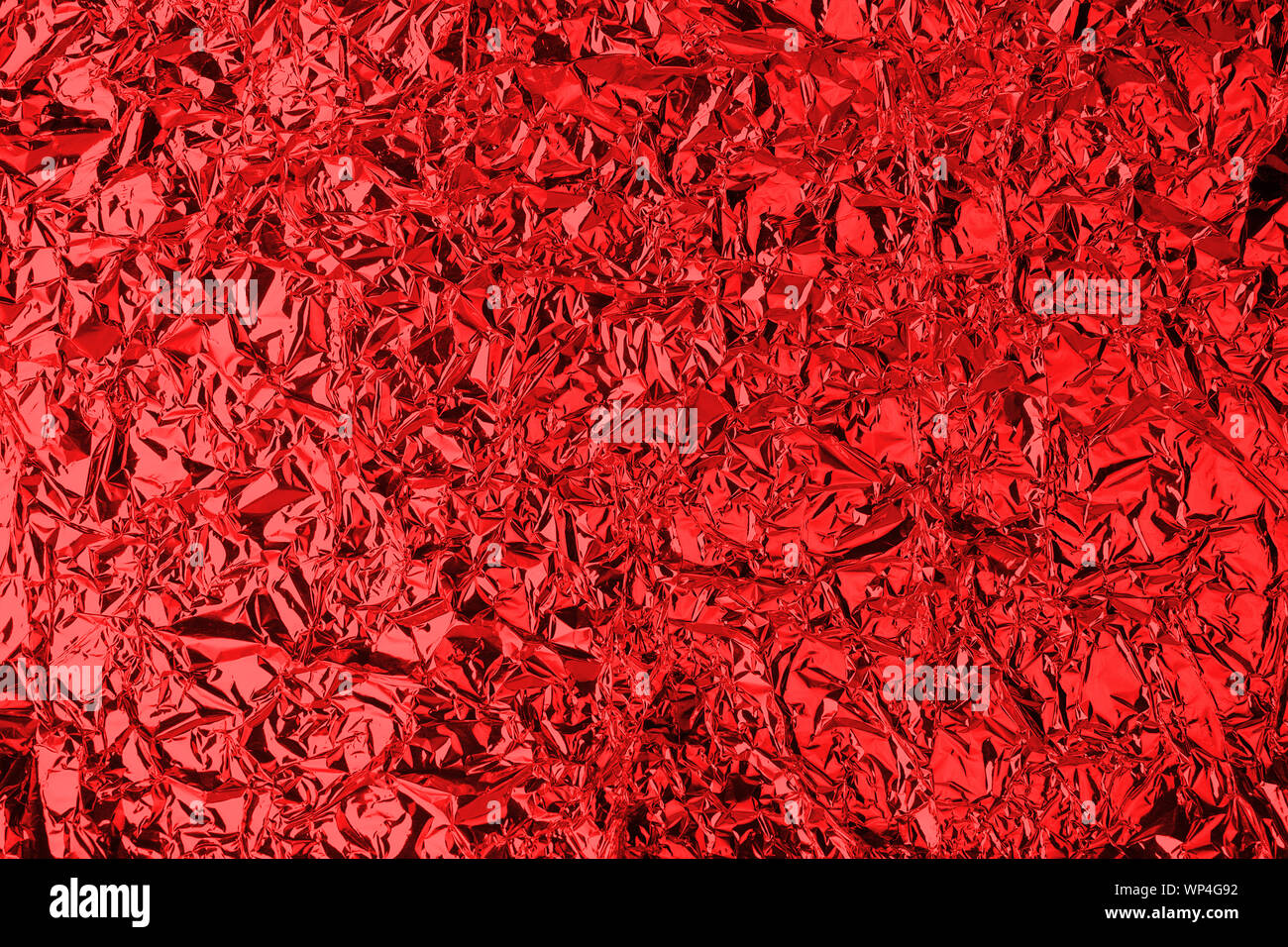 Crumpled red foil shining texture background, bright shiny festive ...