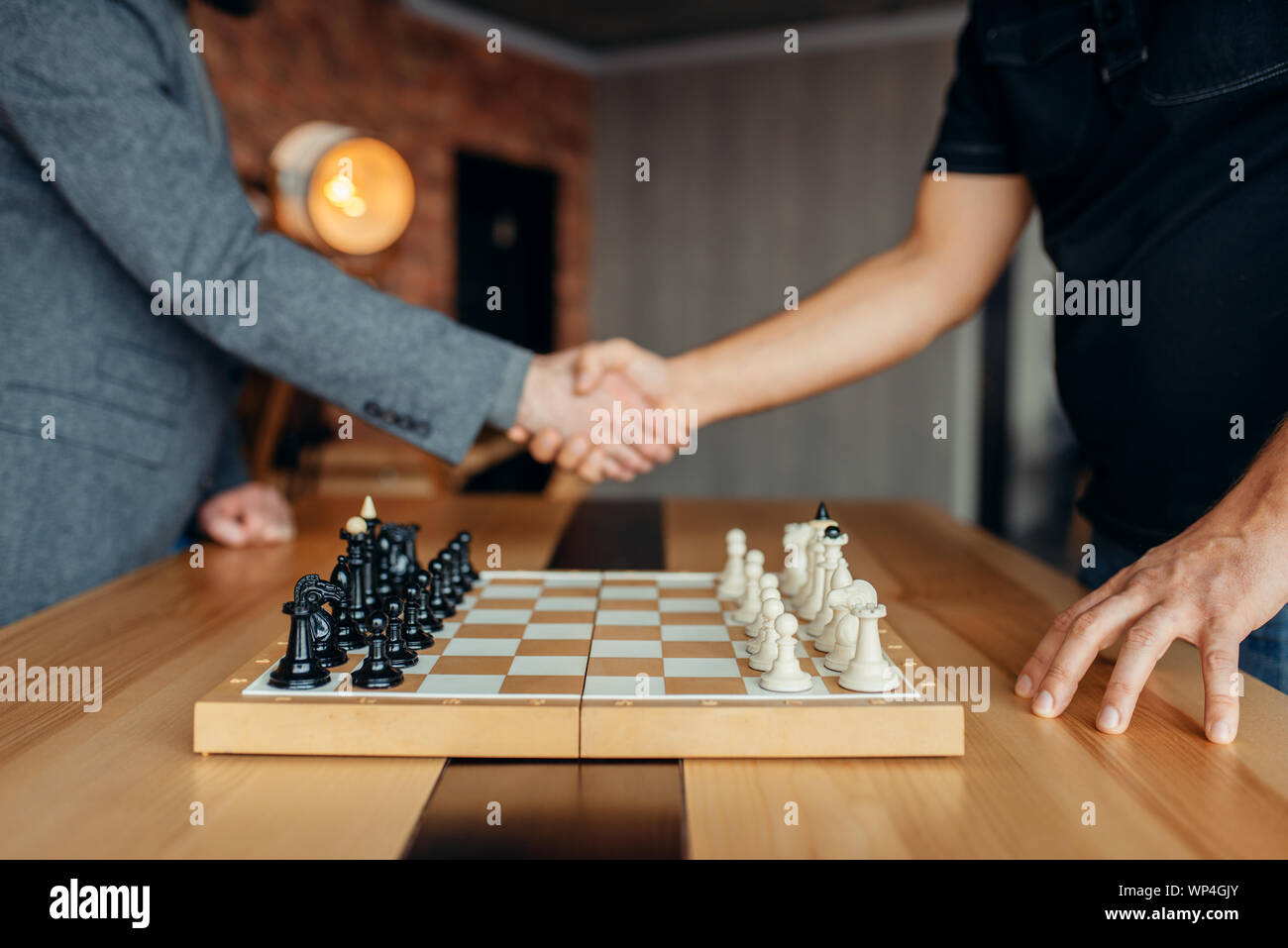 Male chess players shake hands before the game Stock Photo - Alamy