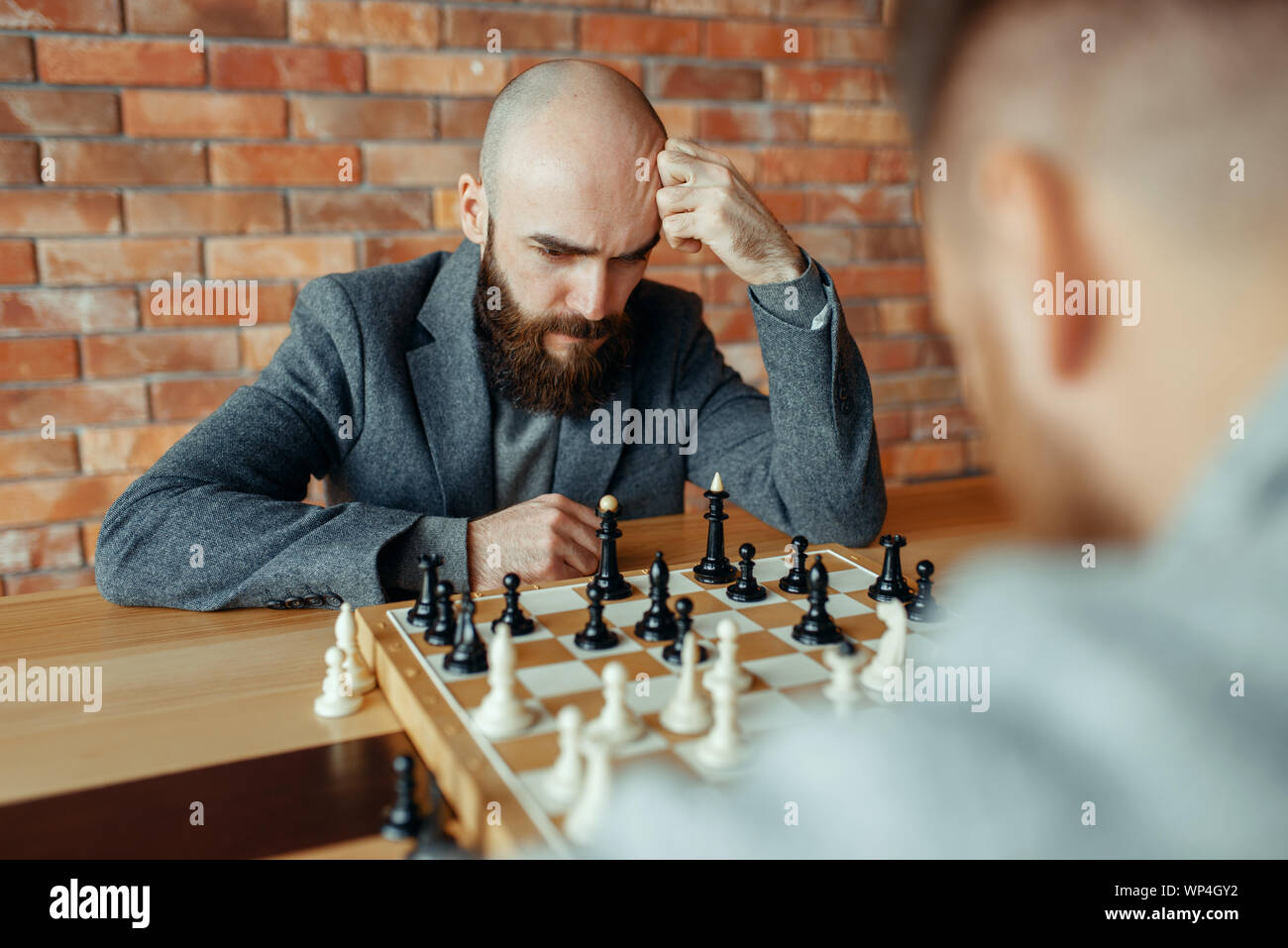 Male chess players playing, thinking process Stock Photo - Alamy