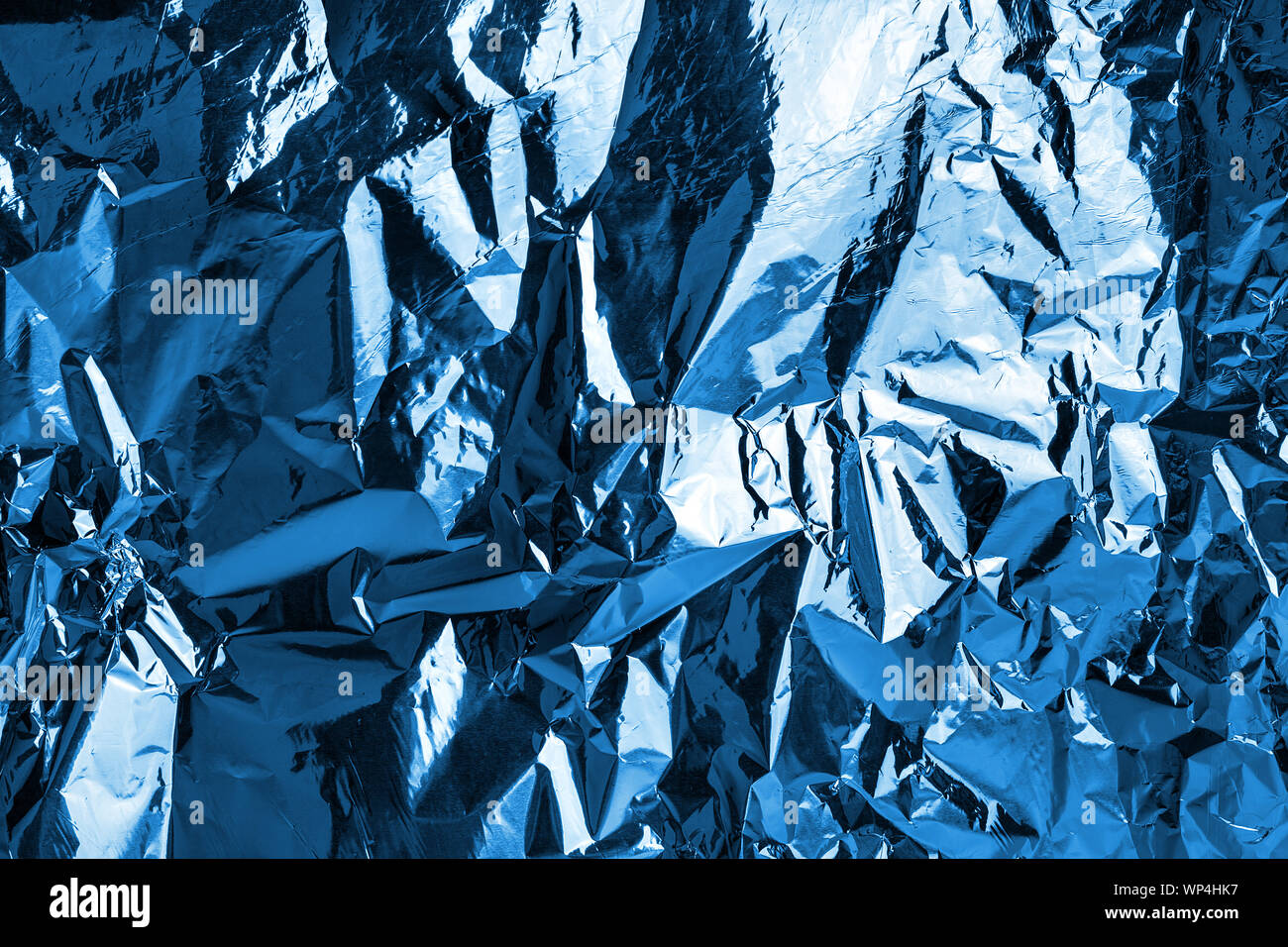 Crumpled blue foil shining texture background, bright shiny cold icy ...