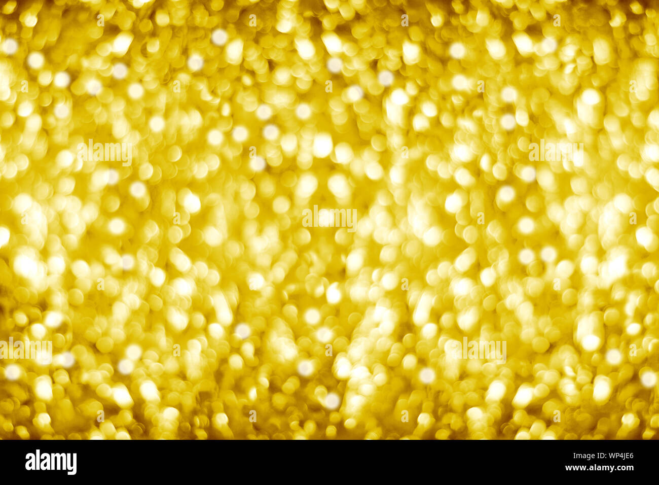 Golden blurred shining bokeh background, defocused yellow sparkles ...
