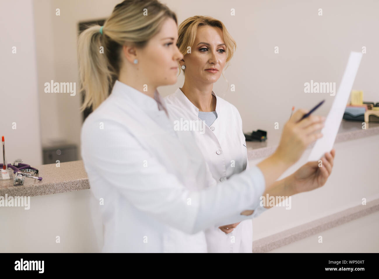 Two female doctors are looking at the results of the medical tests ...