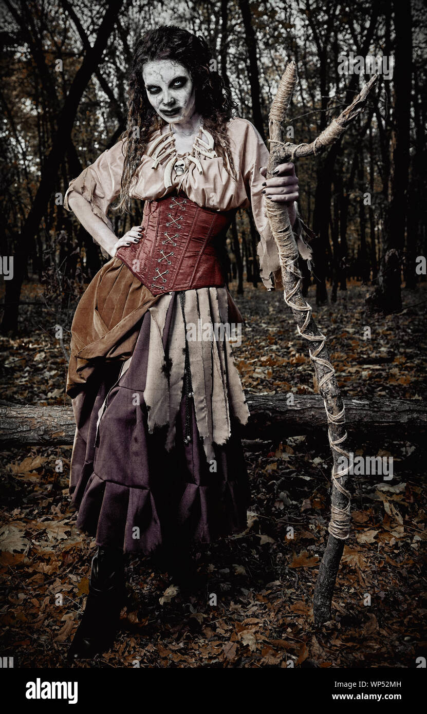 Halloween theme: ugly creepy voodoo witch with staff. Portrait of the ...