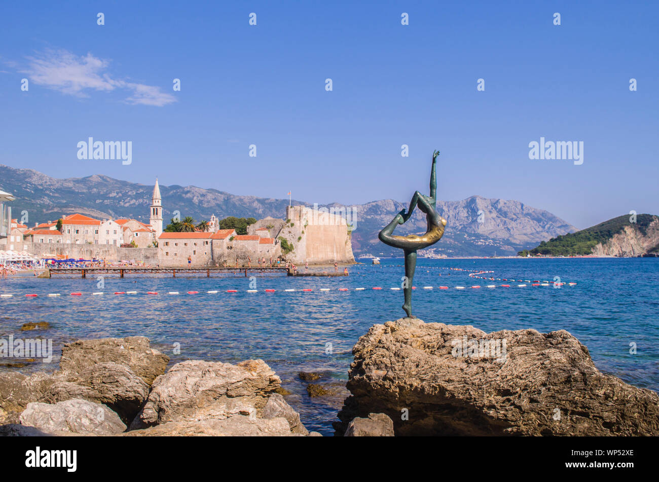 Statue of a ballerina Dancer of Budva against the Old Town of Budva ...