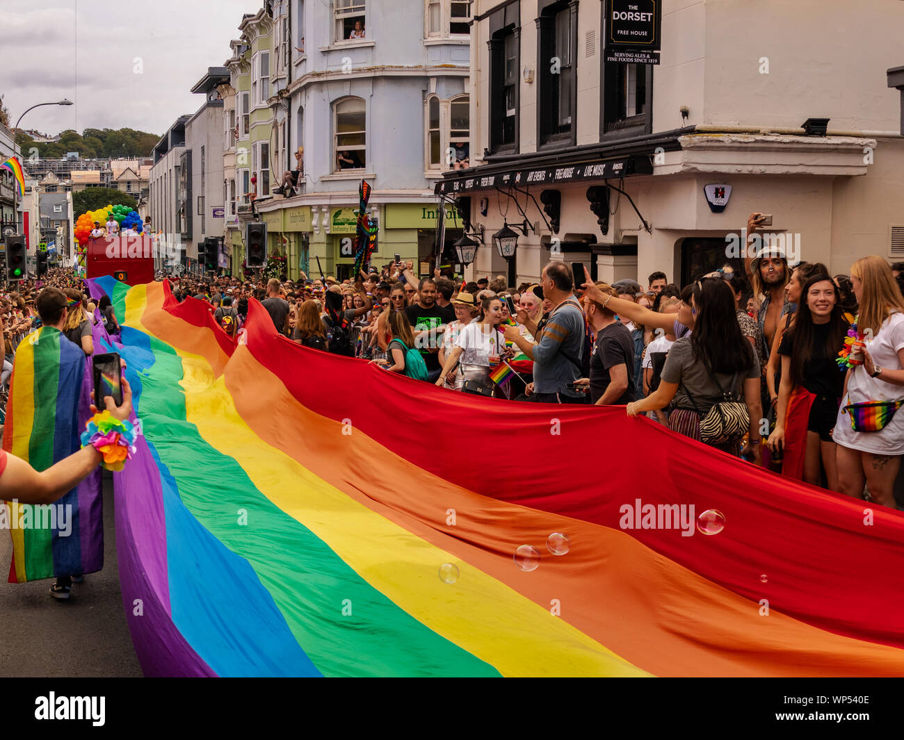 People carrying rainbow flags hi-res stock photography and images - Alamy