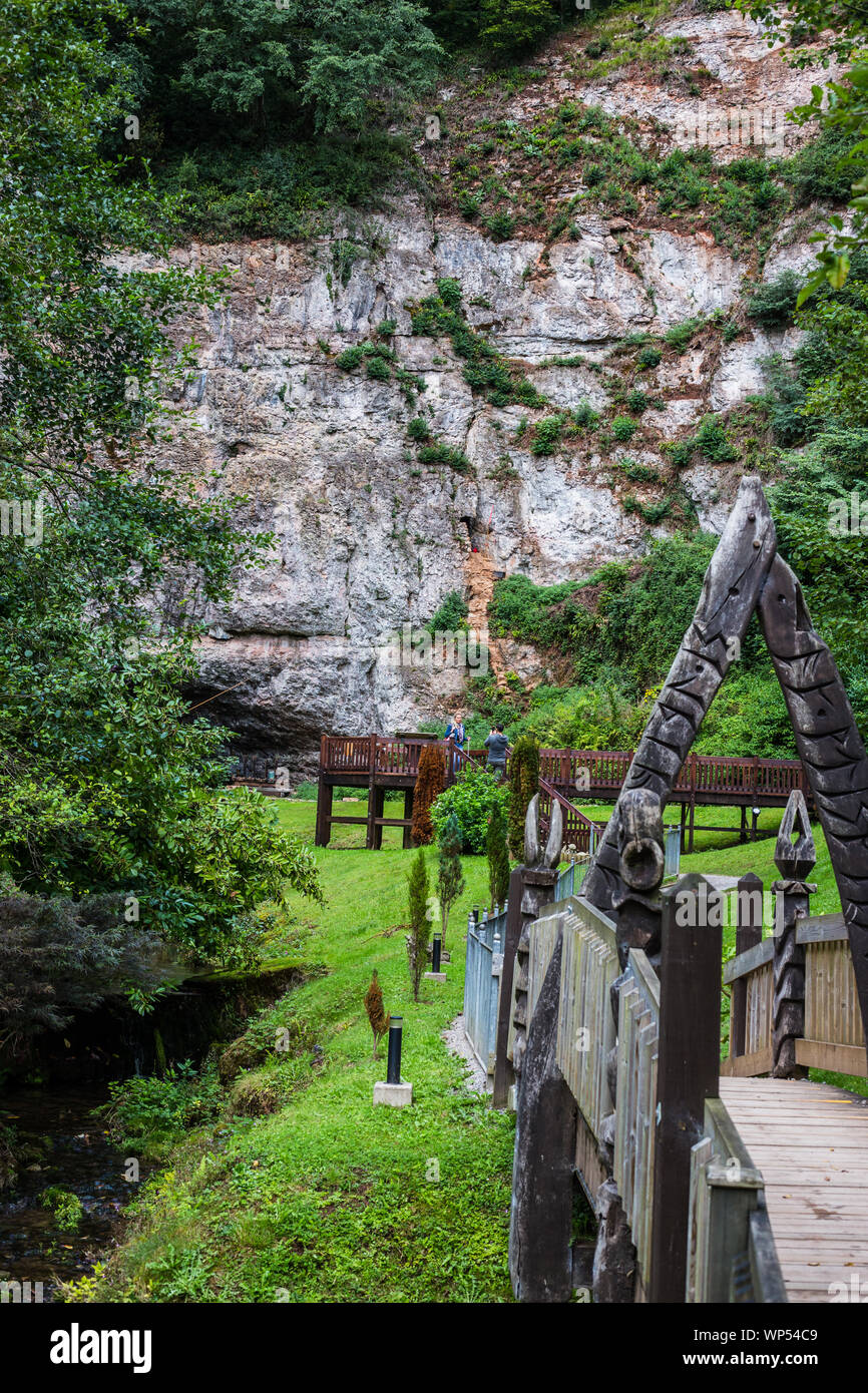 Wookey Hole. Somerset.UK. Cave exit/entrance in the cliff face and a ...