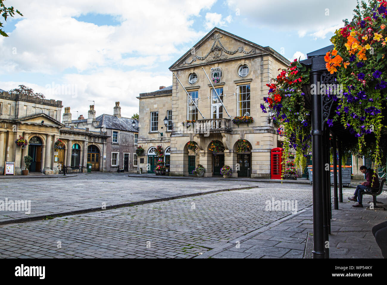 Old Buildings off of Wells Market Square with hanging baskets in the ...