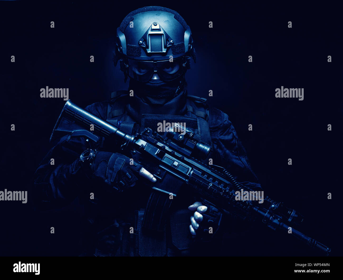 Equipped SWAT team fighter armed assault rifle Stock Photo - Alamy