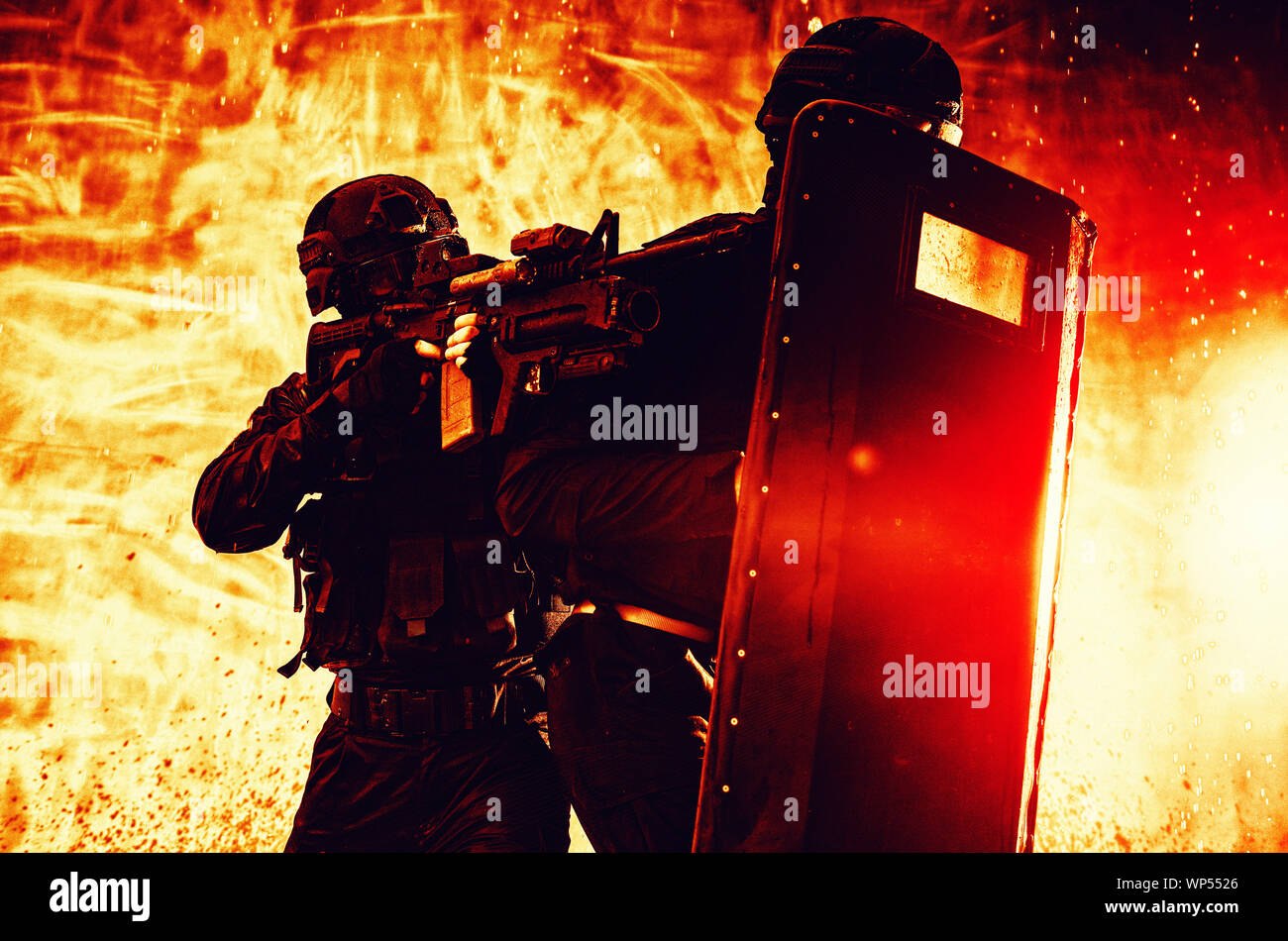 SWAT fighters officers hiding behind ballistic shield Stock Photo - Alamy