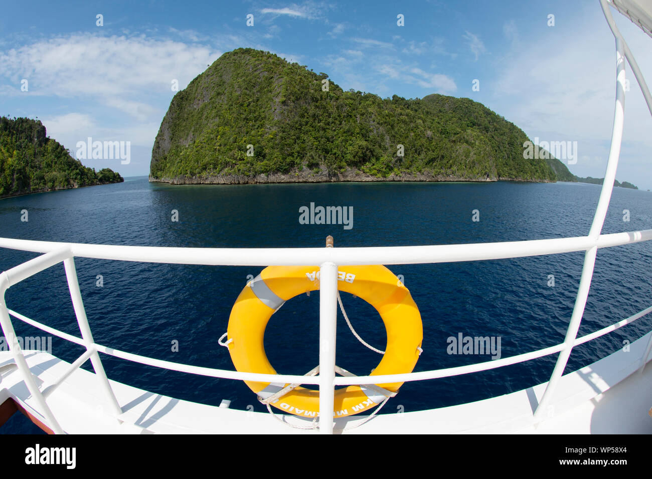 Limestone pinnacle island with life preserver ring, Mermaid liveaboard ...