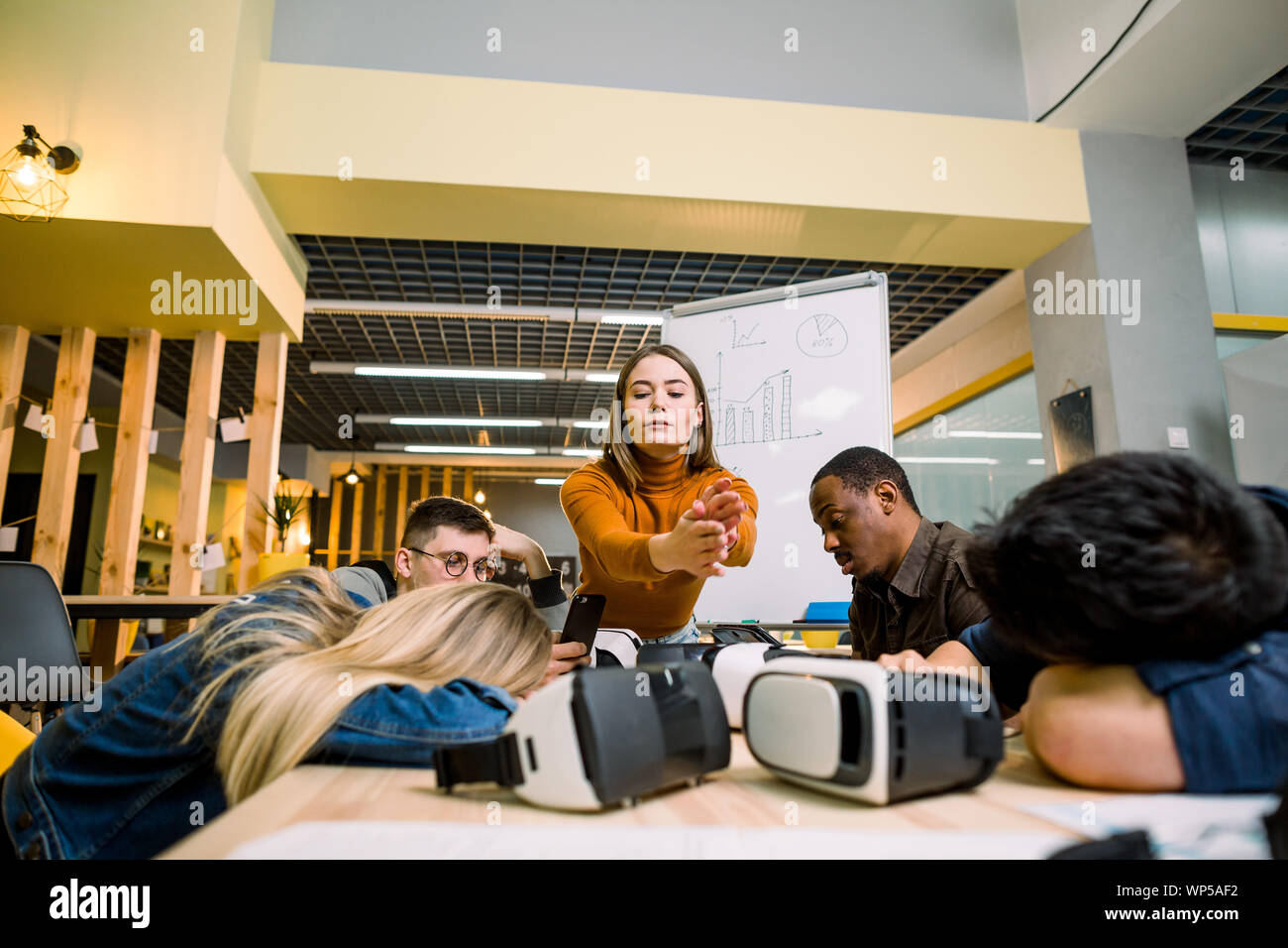 Group of multiethnical business people in casual wear exhausted from hard work and overworking ...