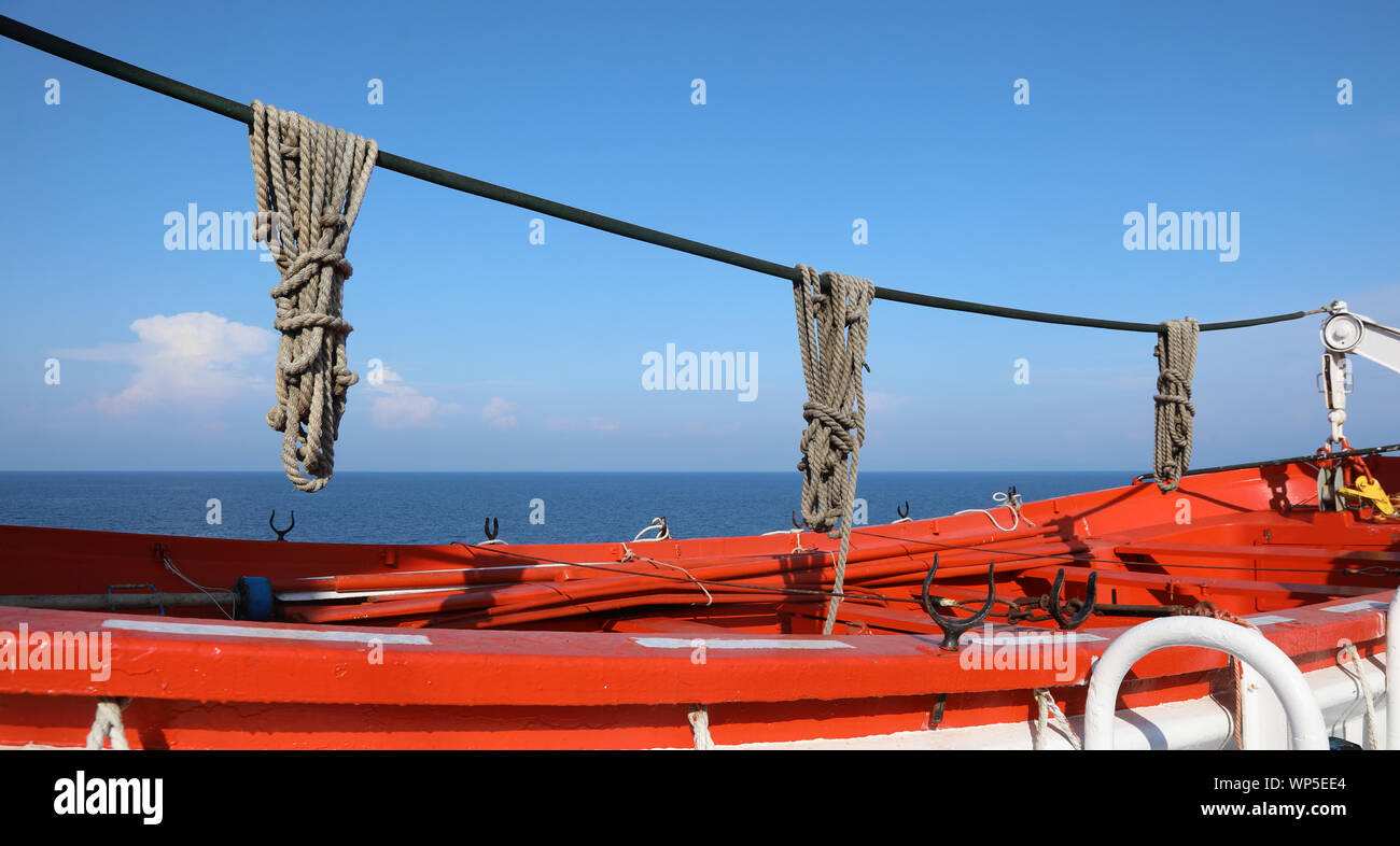 big red lifeboat with ropes in a cruise ship off the ocean Stock Photo ...
