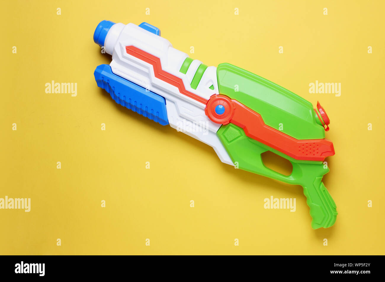 Water Gun on Yellow Background Stock Photo - Alamy