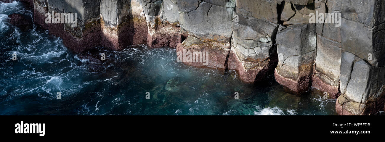 Abstract black lave basalt rock formation walls at the Ponta do ...