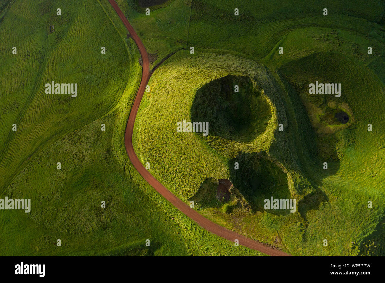 Aerial top view showing a small volcanic crater and road in the ...