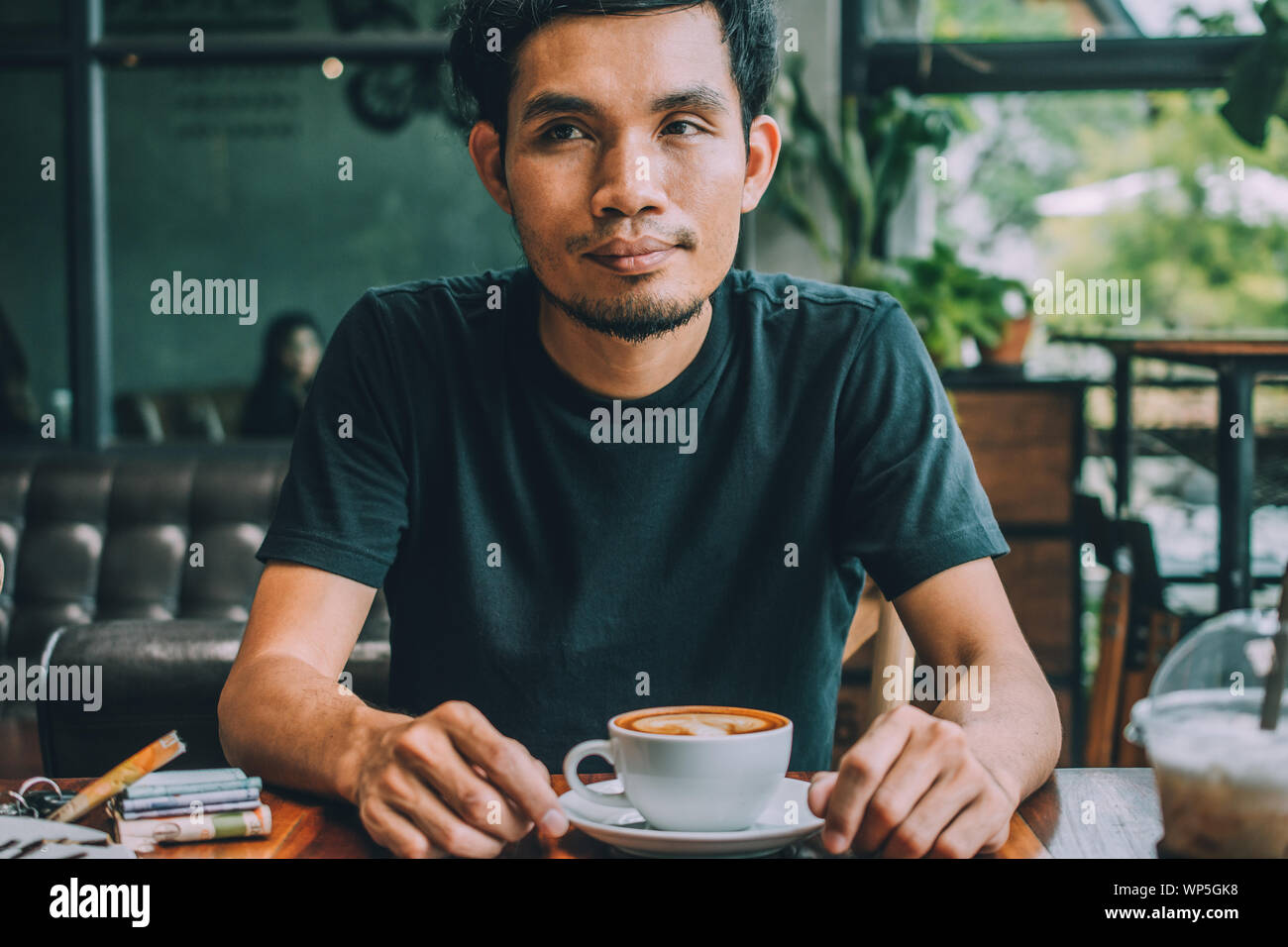 Man sitting in coffee shop for drink in coffee time Stock Photo - Alamy
