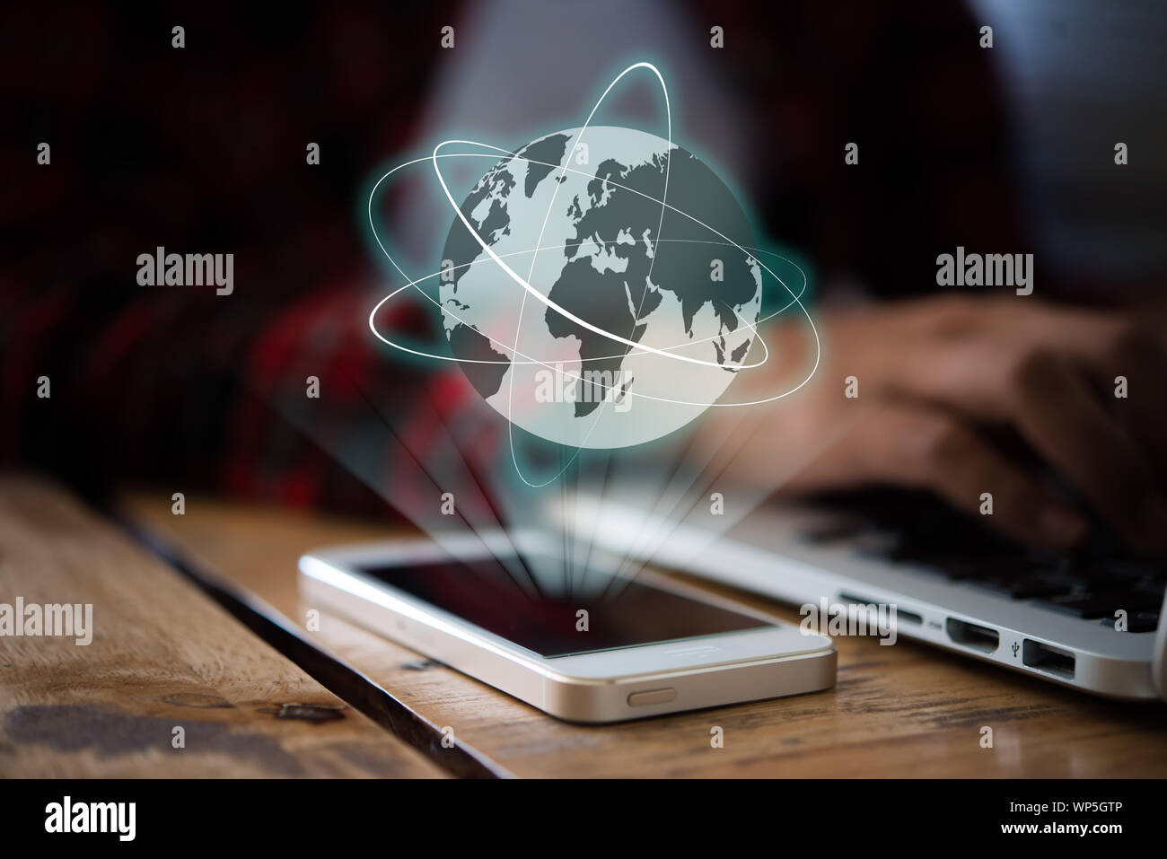 Women work on laptop with global exposure on smartphone screen. Digital ...