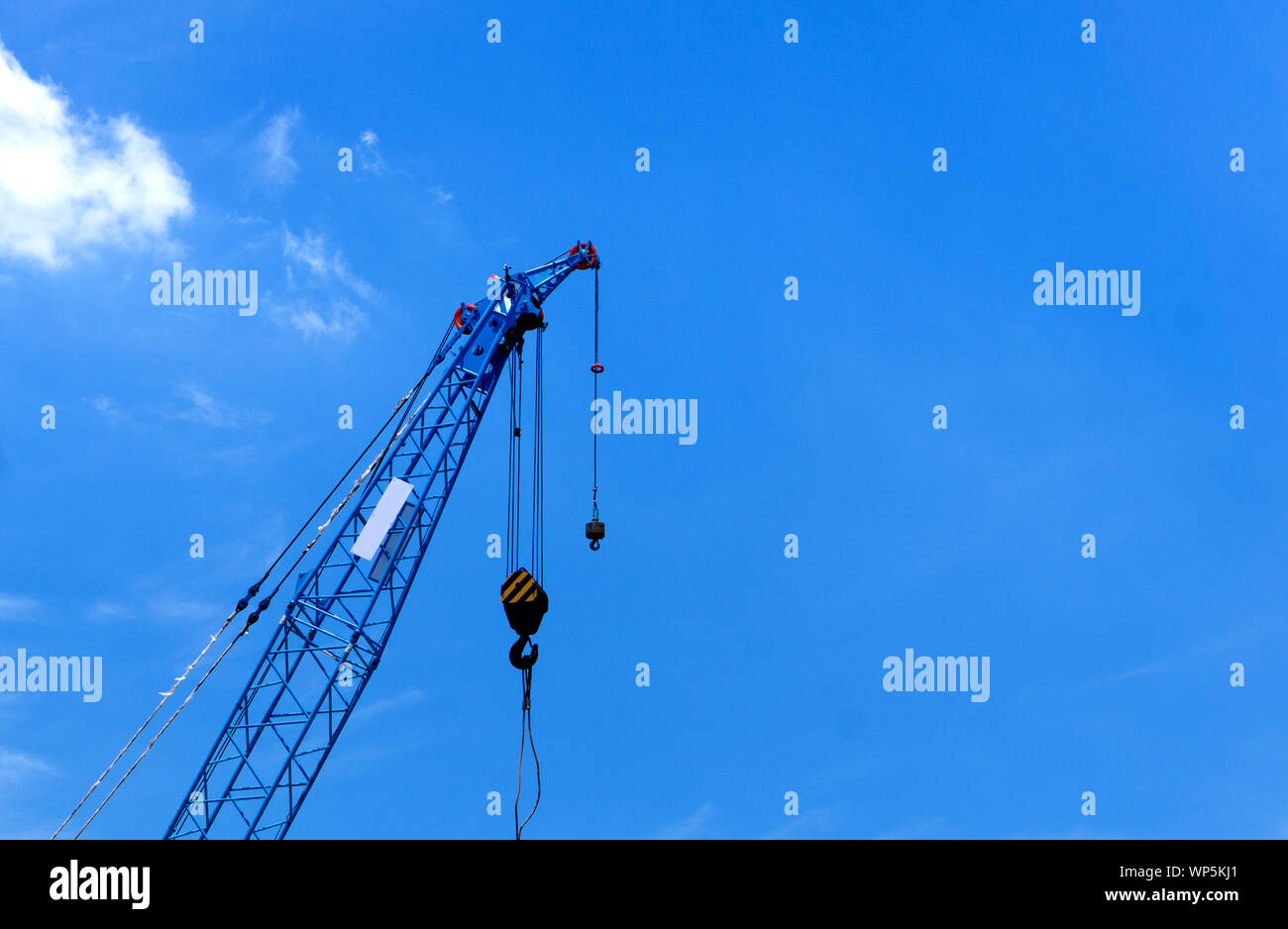 Blue Construction crane on blue sky background in progress at ...