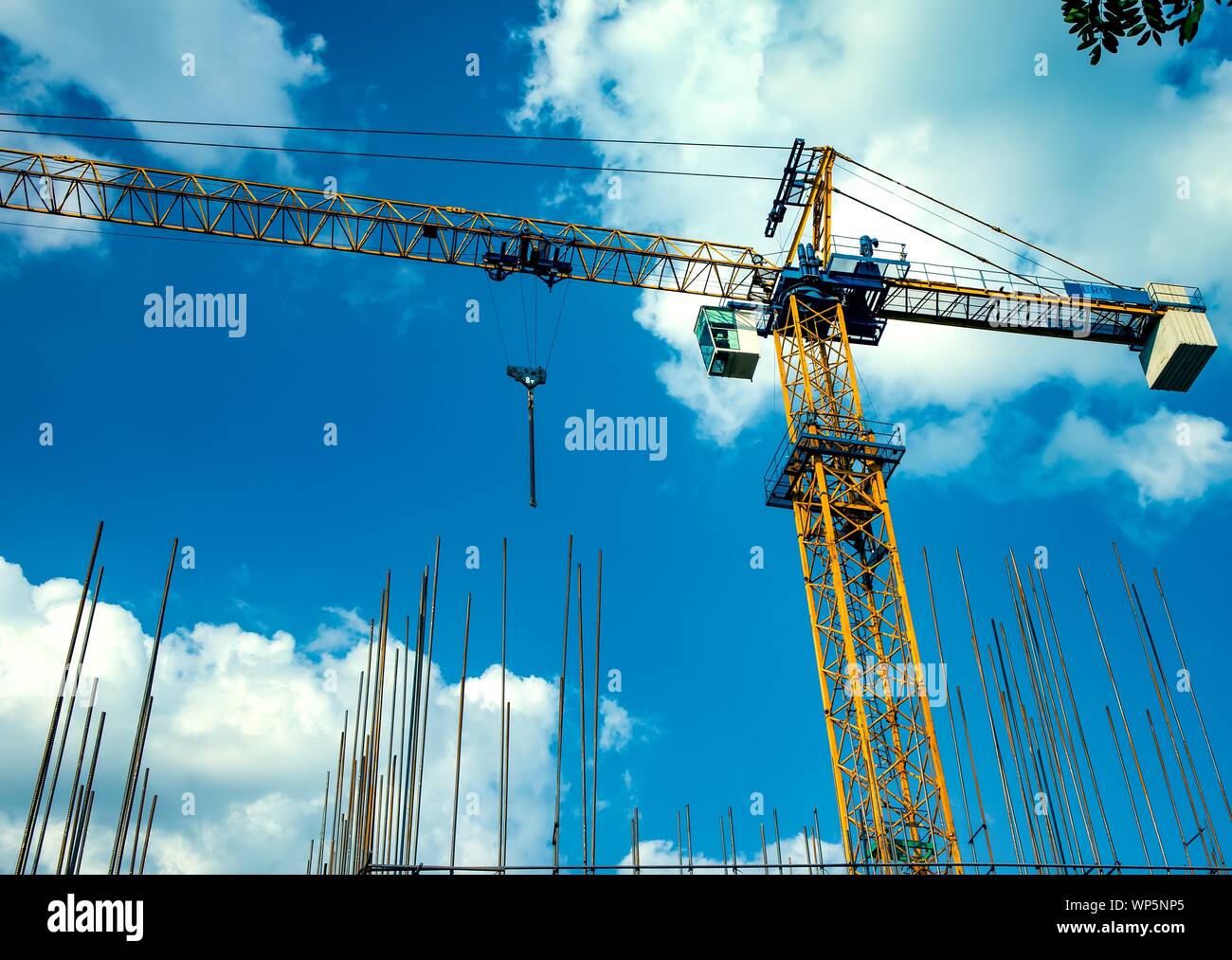 Yellow crane in the construction process with sticks under it and with ...