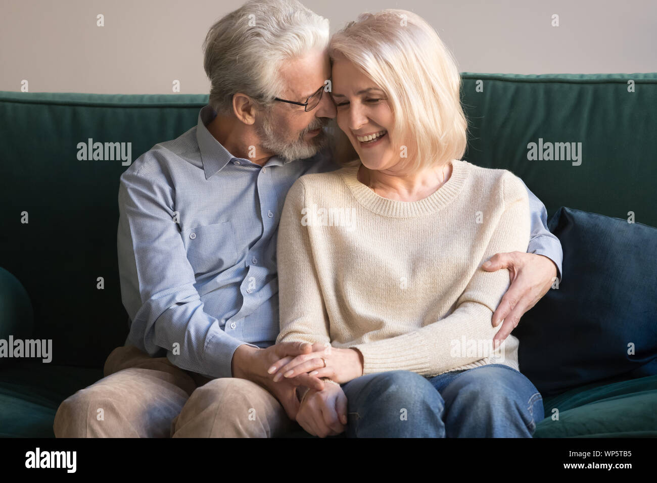 Elder senior smiling happy family couple hugging at home Stock Photo ...