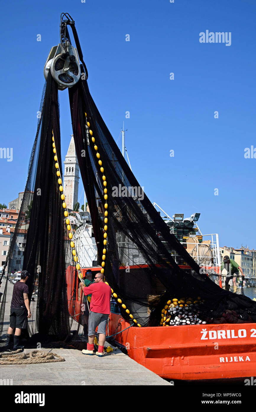 Preparing nets for fishing in Rovinj harbour in Croatia Stock Photo - Alamy