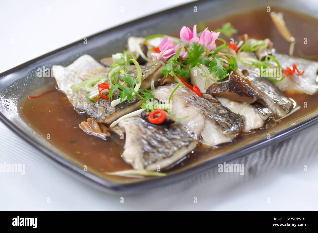 steamed fish, steamed striped bass or stewed bass fish Stock Photo - Alamy