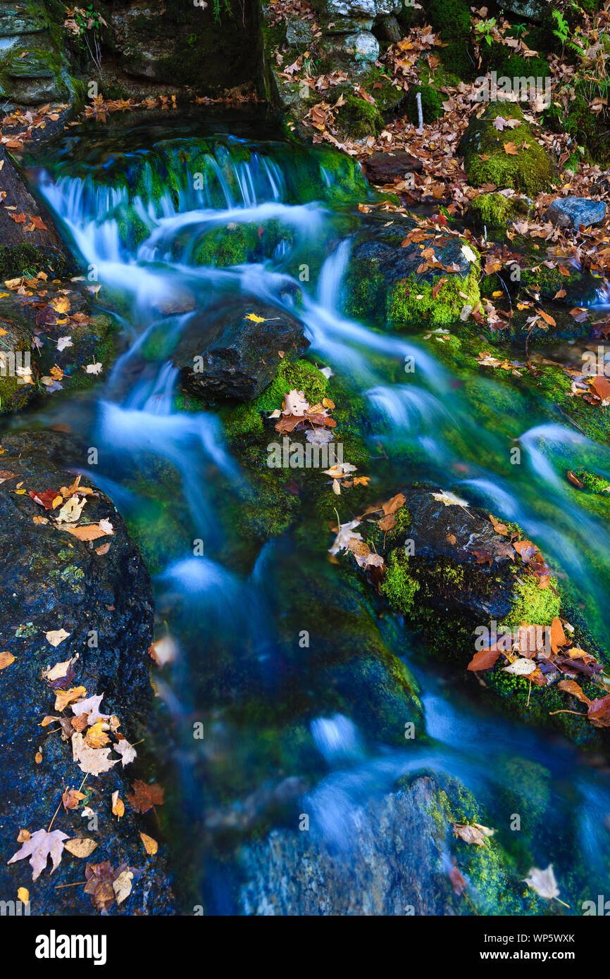 Small stream running through stones during fall foliage, Stowe, Vermont ...