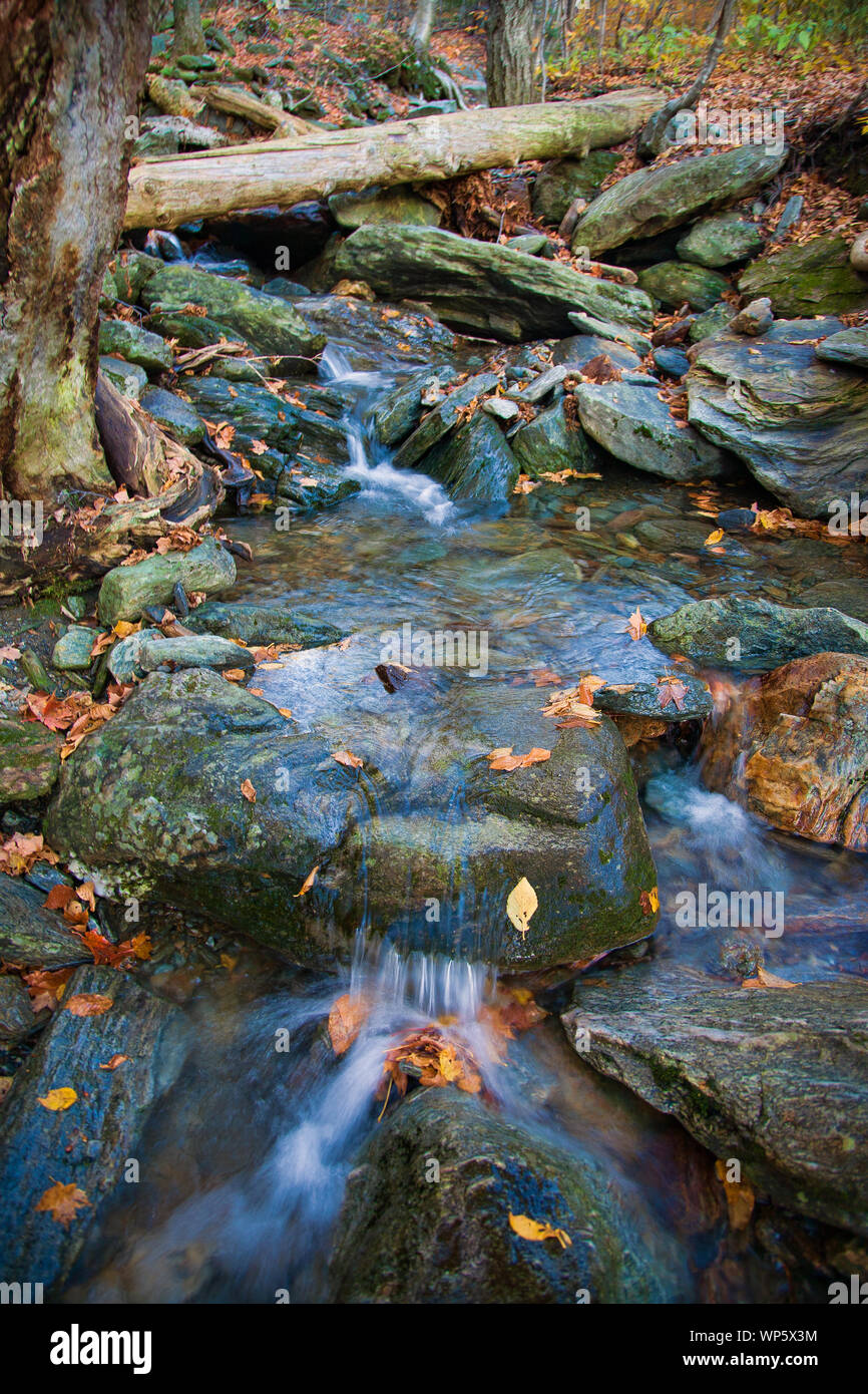 Small stream running through stones during fall foliage, Stowe, Vermont ...