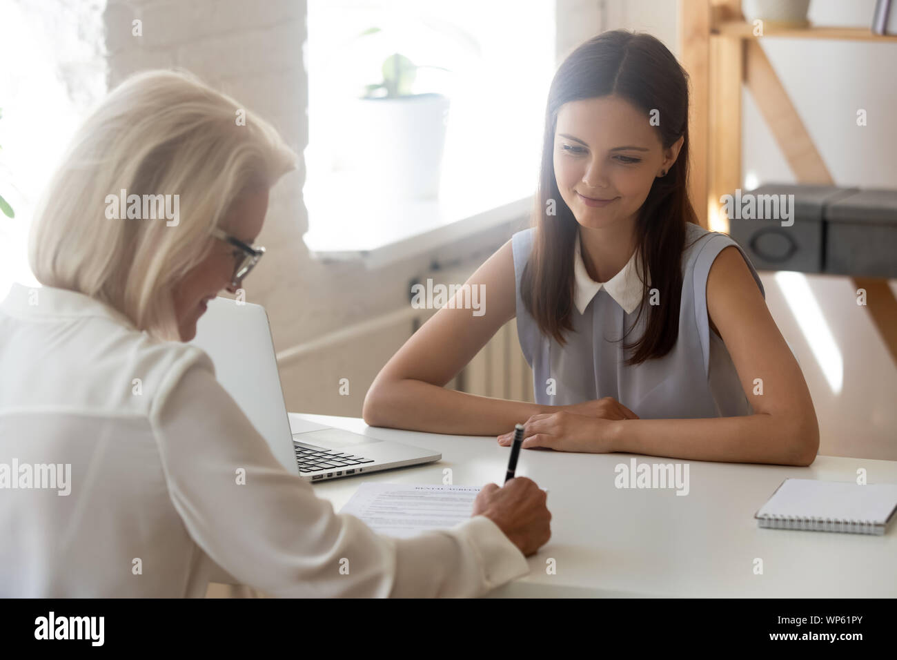 Woman client sign official document at bank specialist office Stock ...