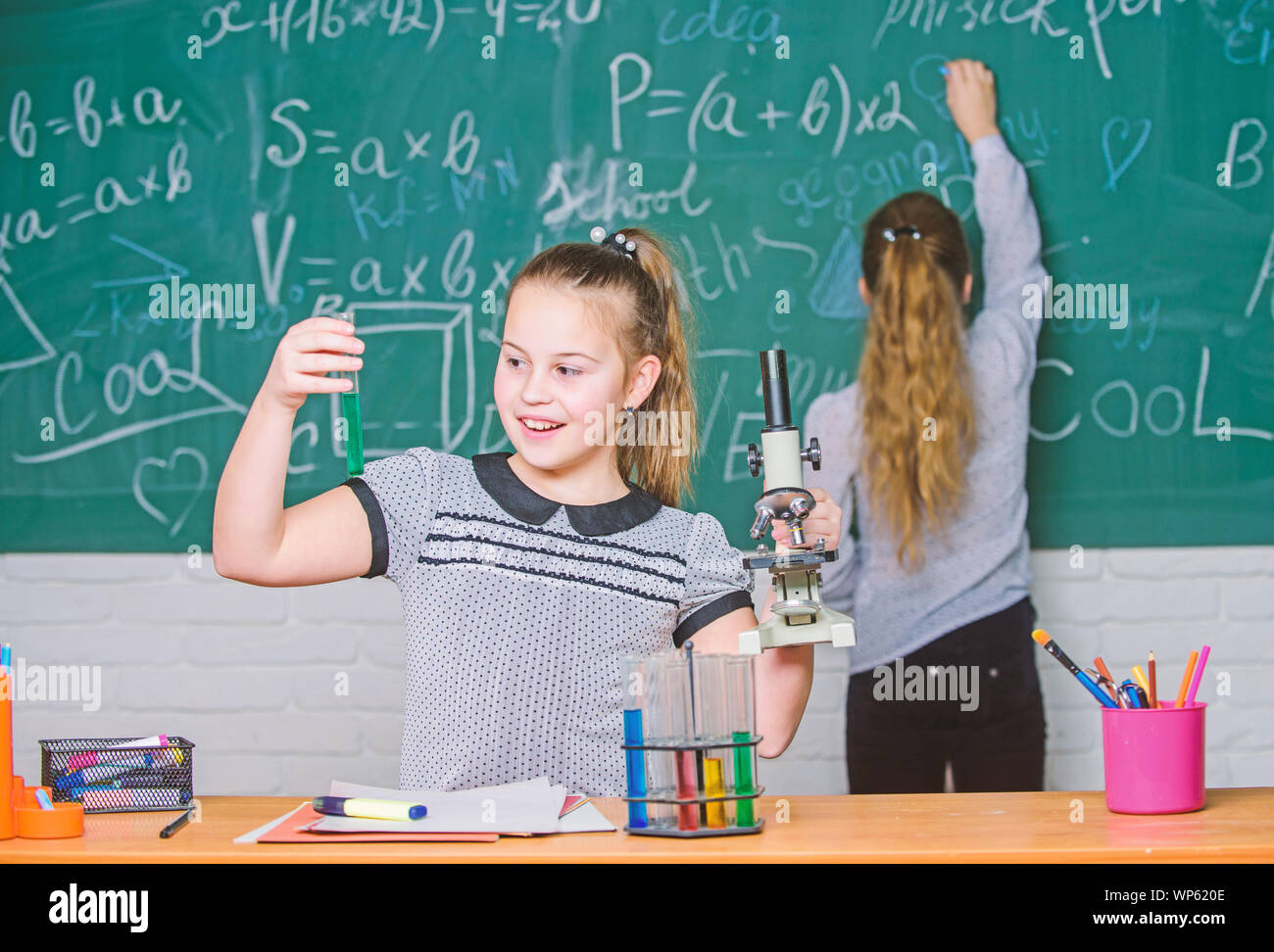 Chemistry classes. Girls classmates study chemistry. Microscope test ...