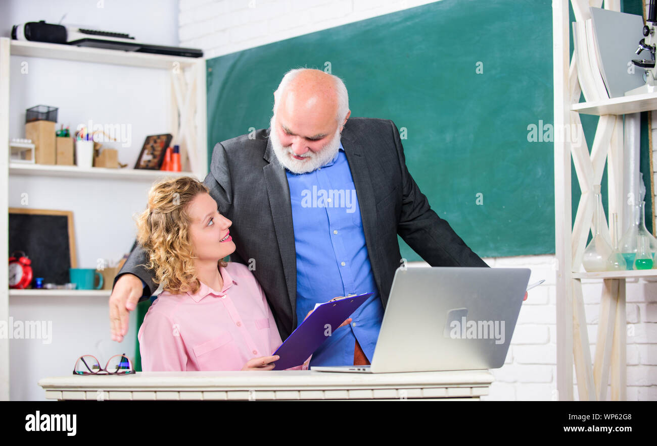 Knowledge test. Pass exam. Man mature school teacher and girl with ...