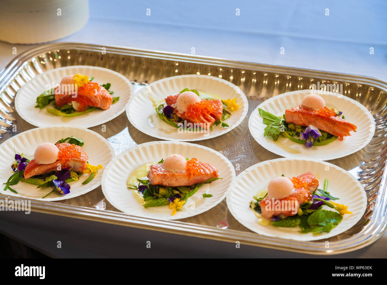 Cooked salmon dinner on a paper plate in a silver tray Stock Photo - Alamy
