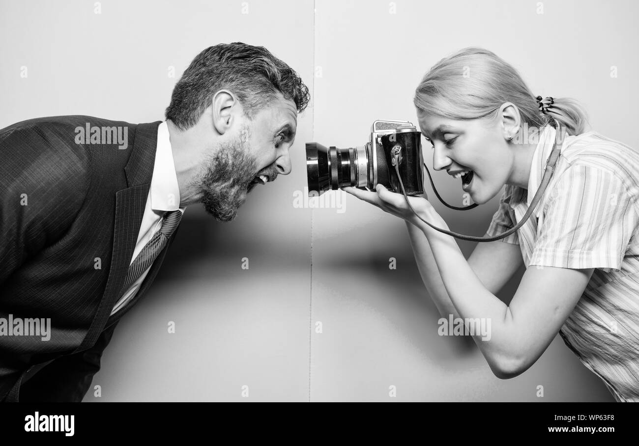 Capturing his face expression. Pretty woman using professional camera ...